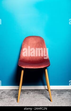 Modern Pink Velour Chair on wooden legs, blue background Stock Photo ...
