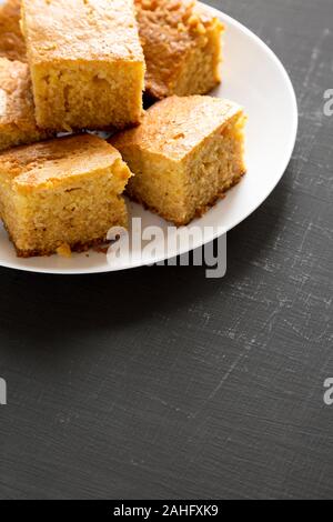 Homemade Sliced Cornbread Ready to Eat on a white plate, top view. Flat ...