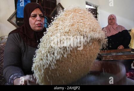Palestinian women prepare "Maftoul", a traditional couscous dish made ...