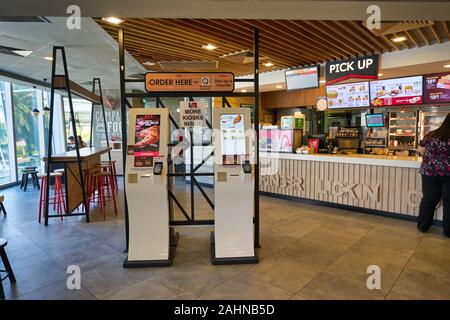 SINGAPORE - CIRCA APRIL, 2019: sales area and self-service kiosk at KFC ...