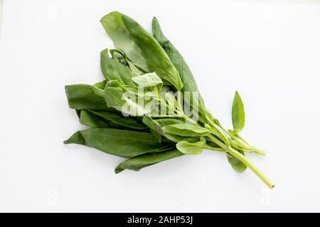 A handful of natural and green basil for cooking on white background ...