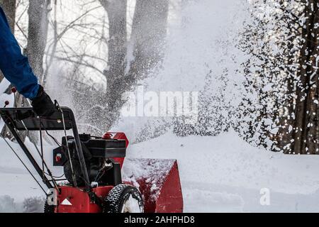 Man pushing snow blower during storm Stock Photo - Alamy