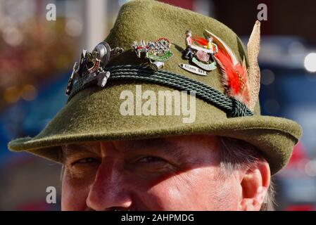 Close up of felt Alpen hat with various collector pins attached, worn ...