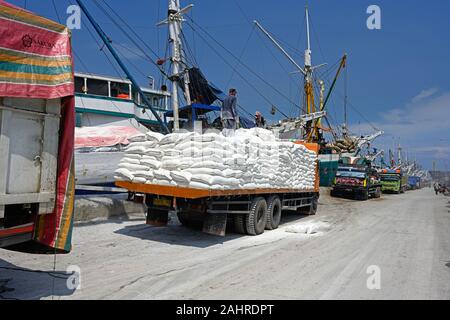 Loading cargo of raw materials from a port mooring Stock Photo - Alamy