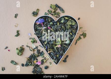 Heap of dry puer tea on green background Stock Photo - Alamy