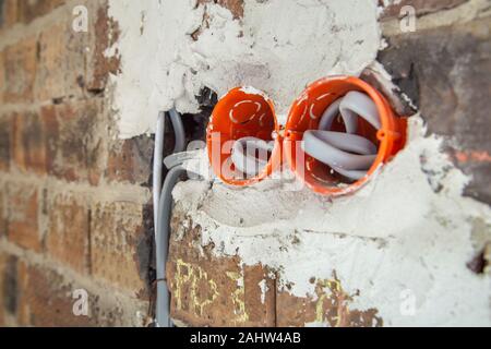 Socket orange boxes with wires in a wall. Cabling installation of ...