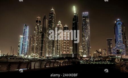 Fantastic nighttime skyline with illuminated skyscrapers. Elevated view of downtown Dubai, UAE ...