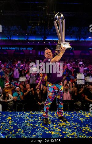 Peter Wright celebrates with the Sid Waddell Trophy after victory ...