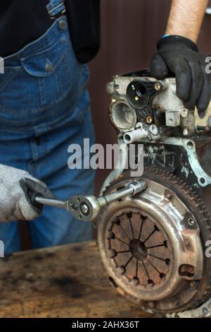 disassemble the engine from the car in the car workshop Stock Photo - Alamy
