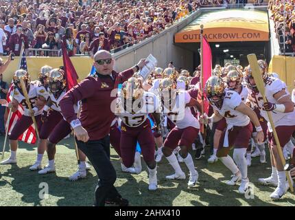 Minnesota head coach P. J. Fleck leads his team onto the field before ...