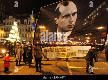 Ukrainian nationalists carry torches and banner with Bandera and ...