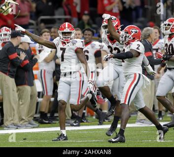 Georgia defensive back Richard LeCounte (2) holds up Andrew Smart, son ...