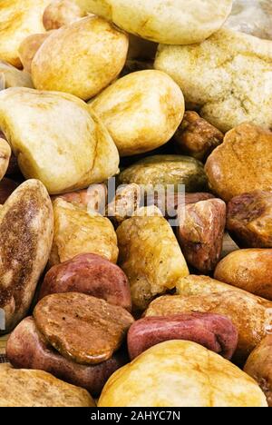 A pile of smooth, shiny river rocks on a white background Stock Photo ...