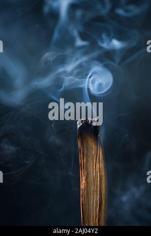Palo Santo stick incense burning on gray stone background. Esoteric ...