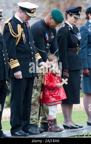 Lance Corporal Ram Patten and his 4-year-old daughter Melanie plant a ...
