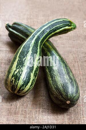 Fresh striped zucchini on sackcloth background with copy space Stock ...