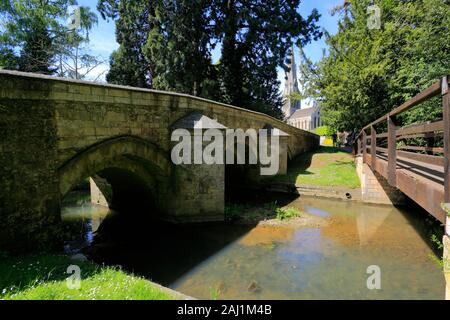 Stone bridge over the river Chater, St Marys church, Ketton village ...