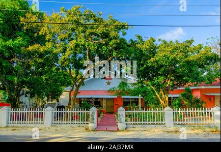 Caribbean-style house with a corrugated tin roof and a veranda in ...