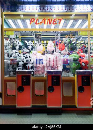 Toy grab claw machine at a funfair arcade Stock Photo - Alamy