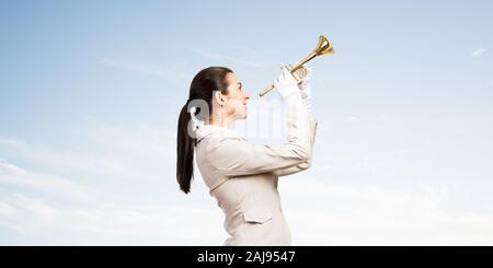 Business woman playing the trumpet Stock Photo - Alamy