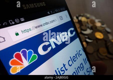CNBC logo on smart phone screen , , background is a keyboard , Sydney ...