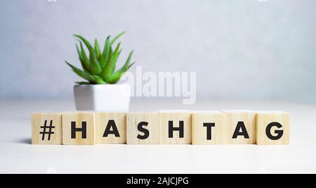 Wooden cubes with a Hashtag and the word Happy, smile and heart, social ...