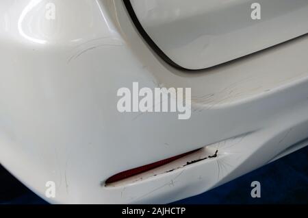 Cracks rear bumper white car Stock Photo - Alamy
