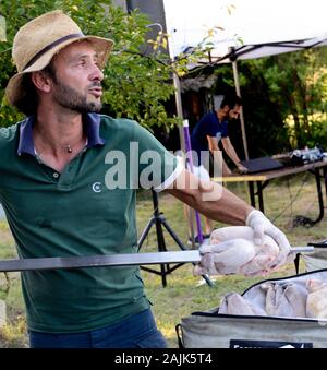 MAN ROASTING CHICKEN Stock Photo - Alamy