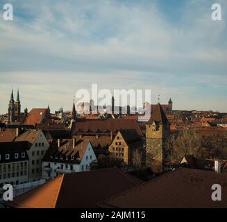 Aerial shot of a beautiful old castle and tower in the middle of the ...