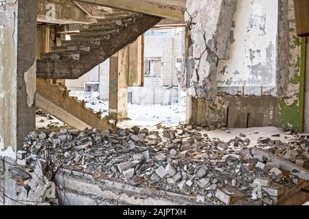 Stairwell concrete buildings littered with debris of stones and ...