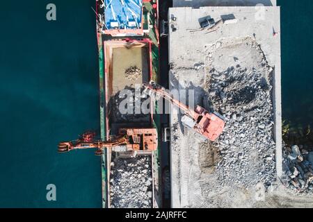 Mining machinery working on cargo ship Stock Photo - Alamy