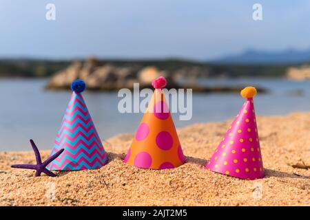 Colorful party hats at the beach Stock Photo - Alamy