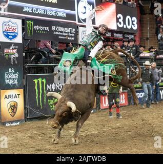 Professional bull rider Jess Lockwood dismounts ”Birthday Cake” during ...