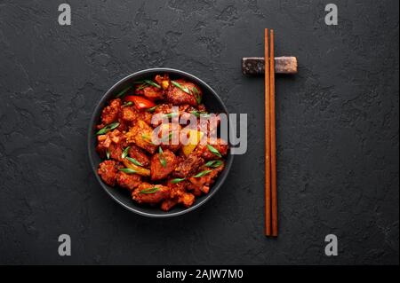 Fish Manchurian dry looks like Schezwan Fish in black bowl at dark ...