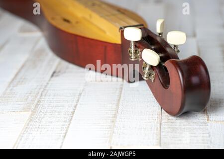 Detail view of an Appalachian mountain dulcimer musical instrument on a ...