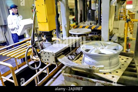 Aluminum car rims are manufactured on the production line at a rim ...