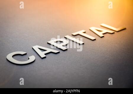 Word capital written with white solid letters on a board. Word capital ...