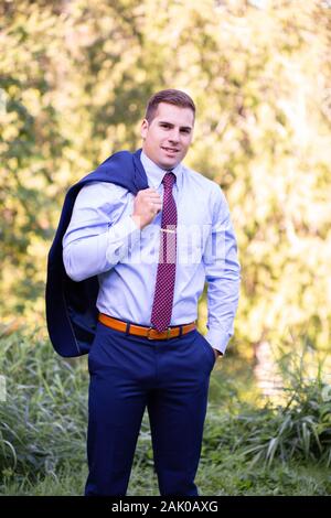 Business man with his suit jacket over shoulder Stock Photo - Alamy