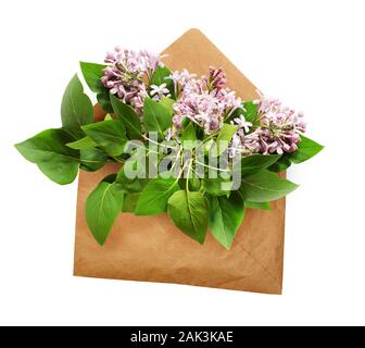 Open mail envelope with lilac flowers and roses on color background ...