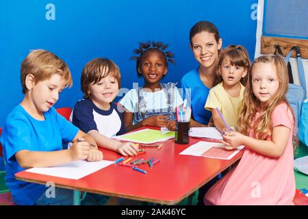 happy children draw together at the table Stock Photo - Alamy