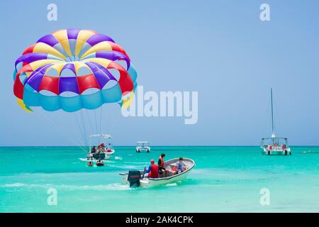 Colorful parasail wing taking off from turquoise water of Sargasso Sea ...