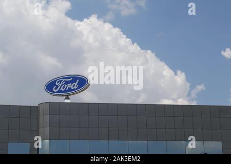 Ford logo on the glass facade of a car dealership Stock Photo - Alamy