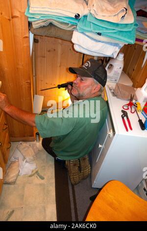 plumber repairing heater Stock Photo - Alamy