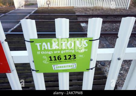 Samaritans sign near railway crossing Stock Photo - Alamy
