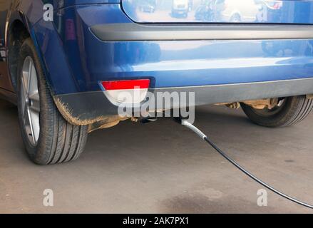exhaust emissions test equipment being used during an MOT check for a ...