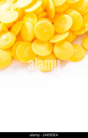 Yellow round chocolate chips for melting chocolate shapes Stock Photo ...