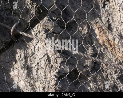 detail of metal mesh and wires used to protect mountain roads from ...