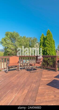 Vertical frame House with balcony overlooking snow capped mountain and ...