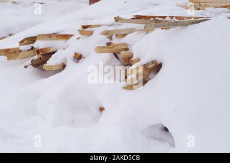 Stack of sawn planks covered with snow. Sawmill background Stock Photo ...