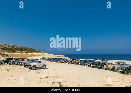 Land Rover Defender 110 on safari crossing the sandy tracks on the ...